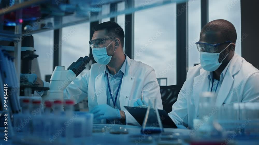 Modern Medical Research Laboratory: Two Scientists Wearing Face Masks ...