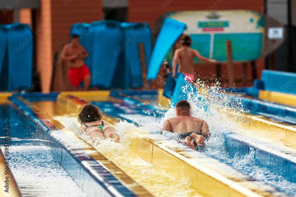 Water park adventure aqua park with cool people having fun on the water ...