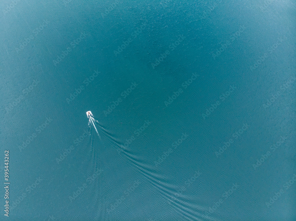 Speed boat quickly floating on the water surface and leaving a trail on ...