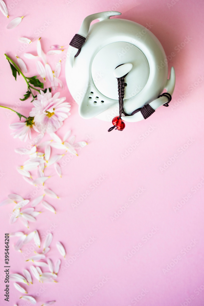 Tea set with cup and teapot as a tea time concept on pink background ...