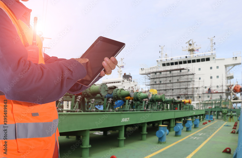 Workers with tablet hand holding in Shipyard Ship repair at mid ship ...