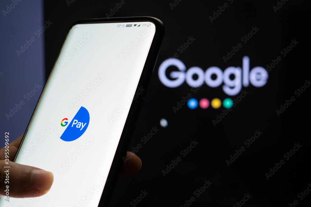 Google Pay app logged in on a mobile infront of a black screen with ...