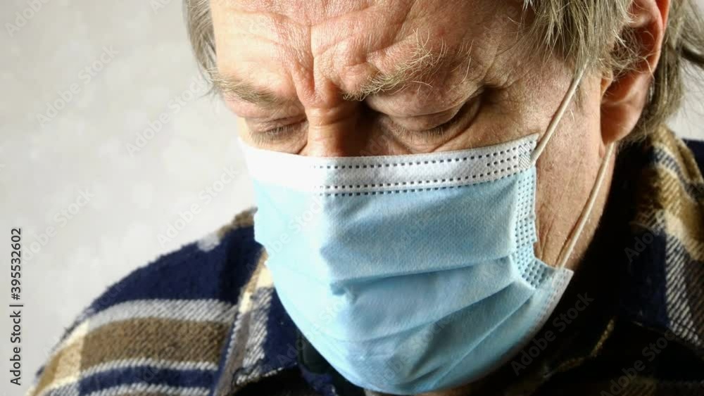 Sick man in medical mask is suffocating, breathing heavily, he does not ...