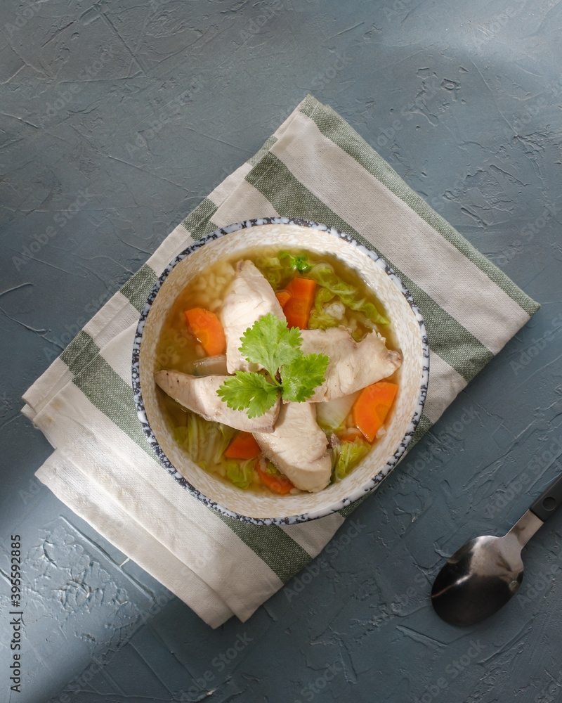 Snakehead fish porridge topped with coriander in a bowl on gray table ...