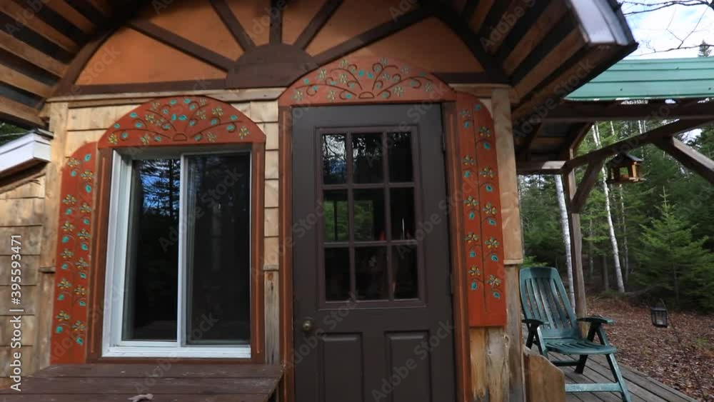 Camera approaching the front door of a very small mini house build from ...