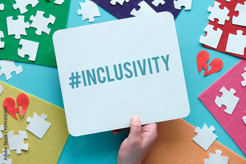 Hand hold paper page with text hashtag Inclusivity. VIbrant geometric ...