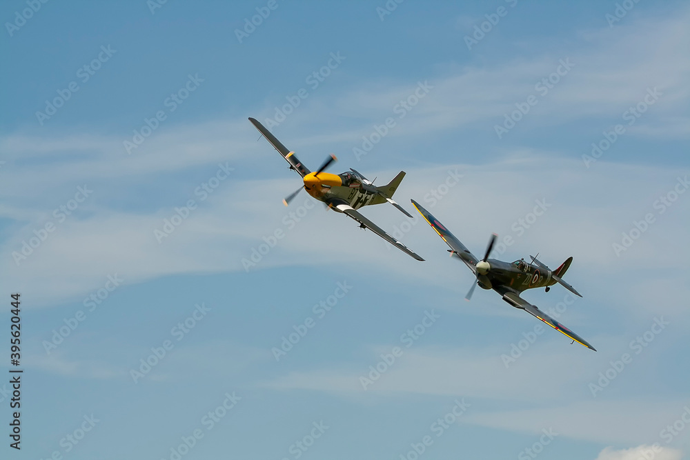 A Supermarine Spitfire and North American P-51 Mustang flying in tandem ...