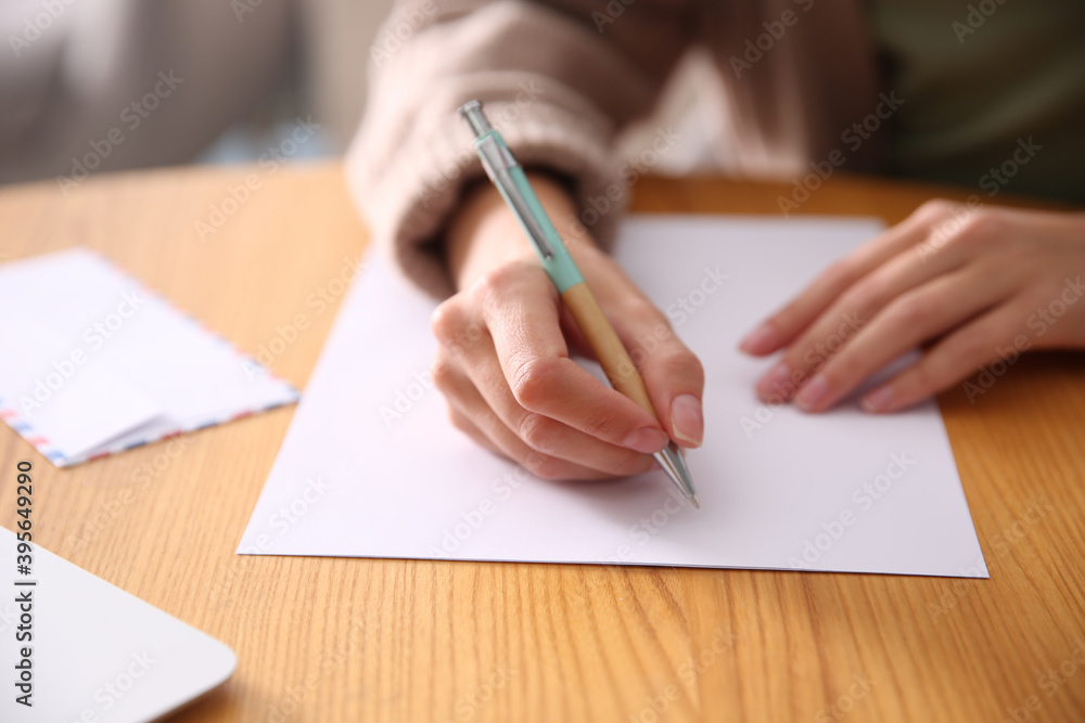 Woman writing letter at wooden table, closeup Stock Photo | Adobe Stock