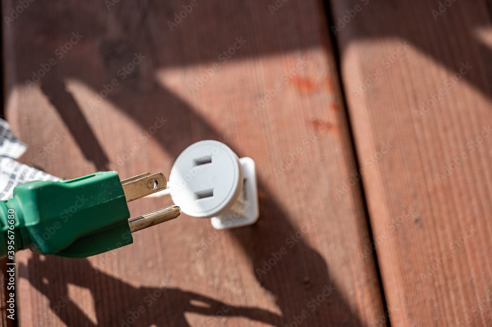 Demonstrating using a 3-prong adapter to connect two power cords Stock ...