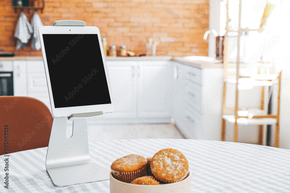 Modern tablet computer on holder in kitchen Stock Photo | Adobe Stock