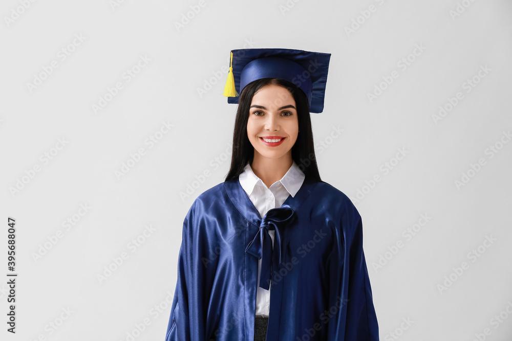 Female graduating student on light background Stock Photo | Adobe Stock