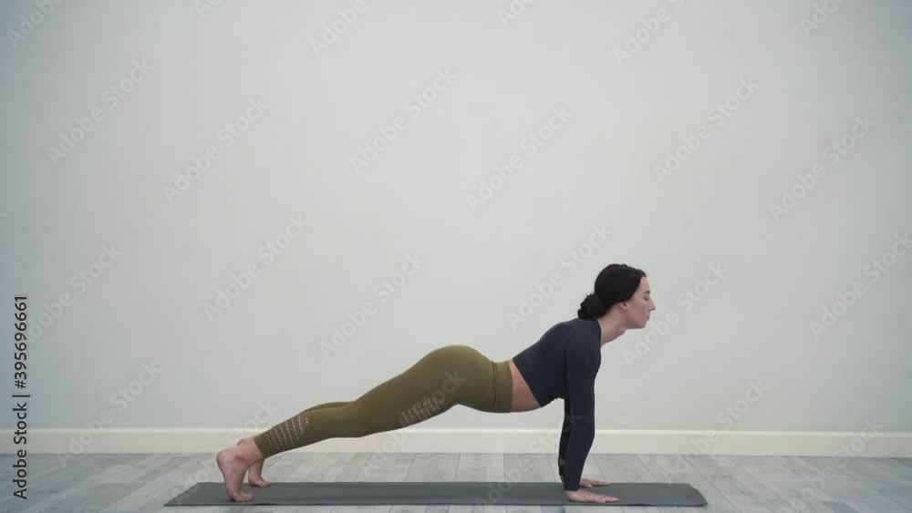 Female athlete doing stretching exercises indoors. Young woman doing ...