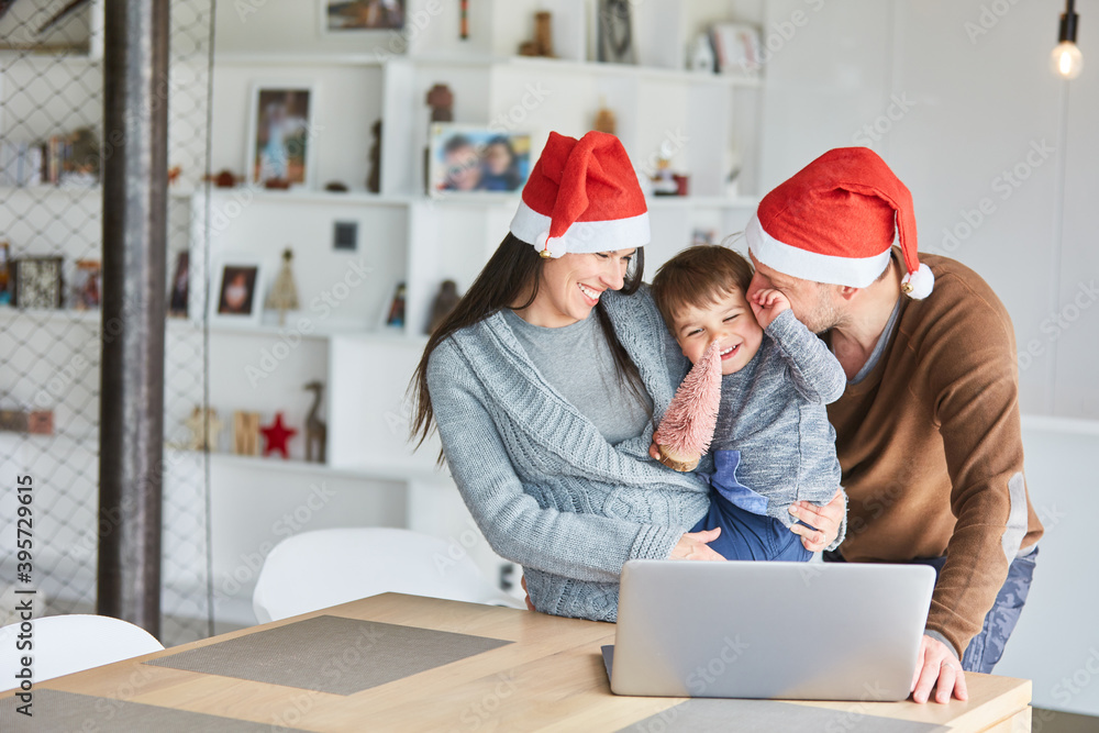 Family with child makes video chat at Christmas Stock Photo | Adobe Stock