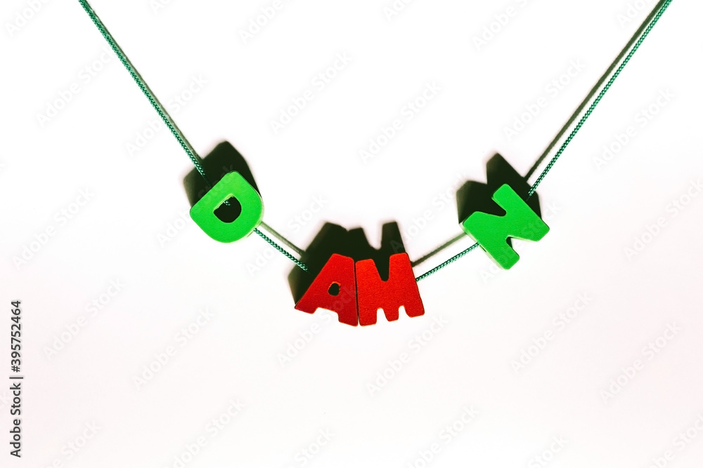 Foto de Damn word text spelling by wooden colorful letters with holes ...