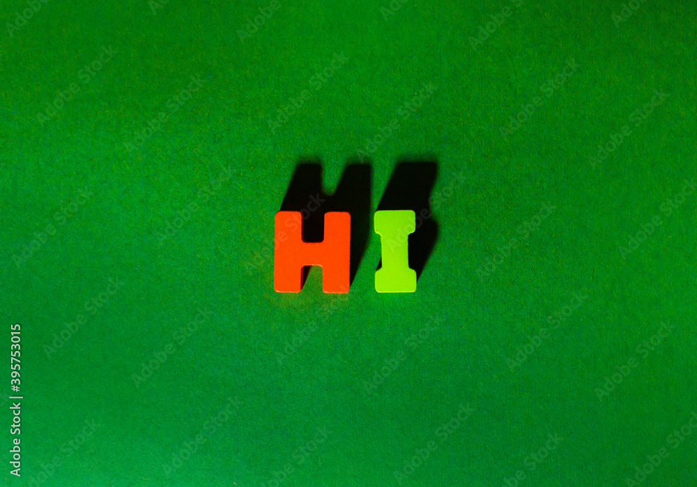 Wooden colorful letters with spelling word text Hi at craft paper green ...