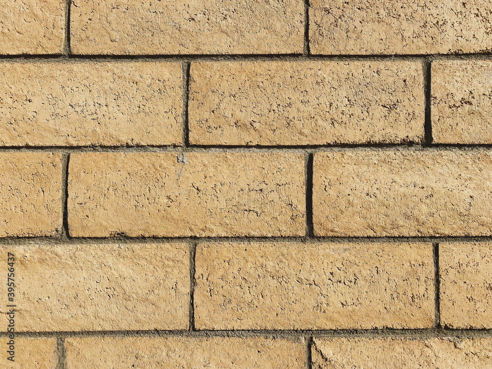 a close out view of tan brick block wall showing grout details ...