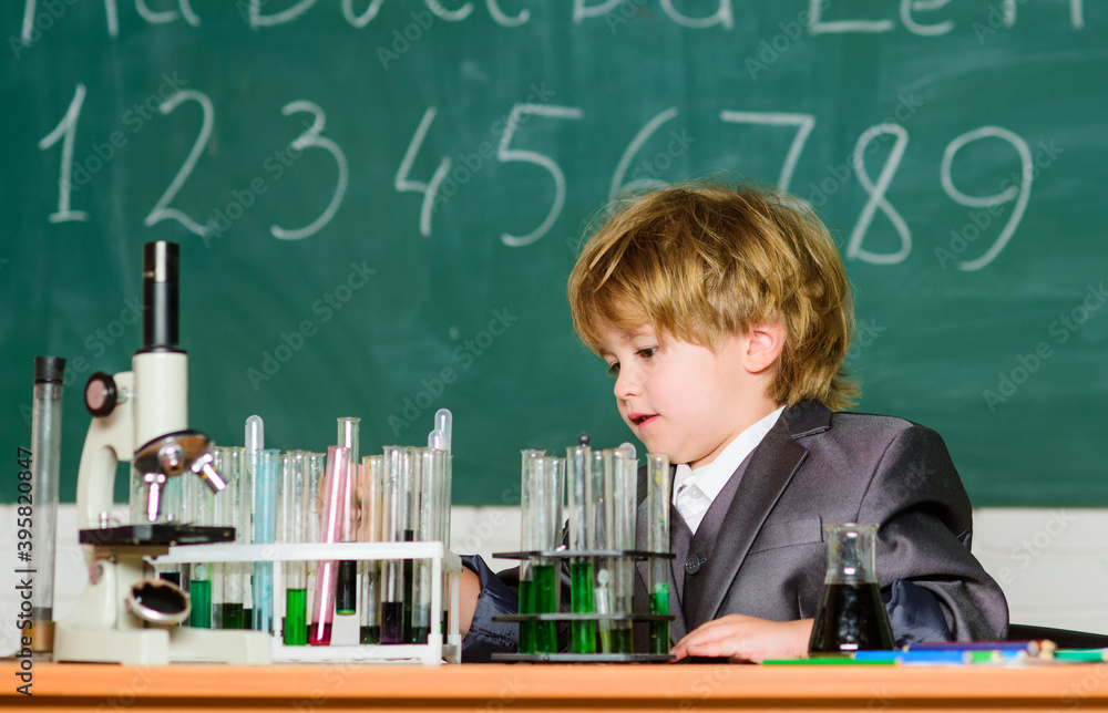 student do science experiment with microscope in lab. small boy at ...