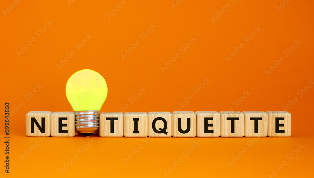 Symbol for netoquette time. Wooden cubes with word 'netiquette'. Yellow ...