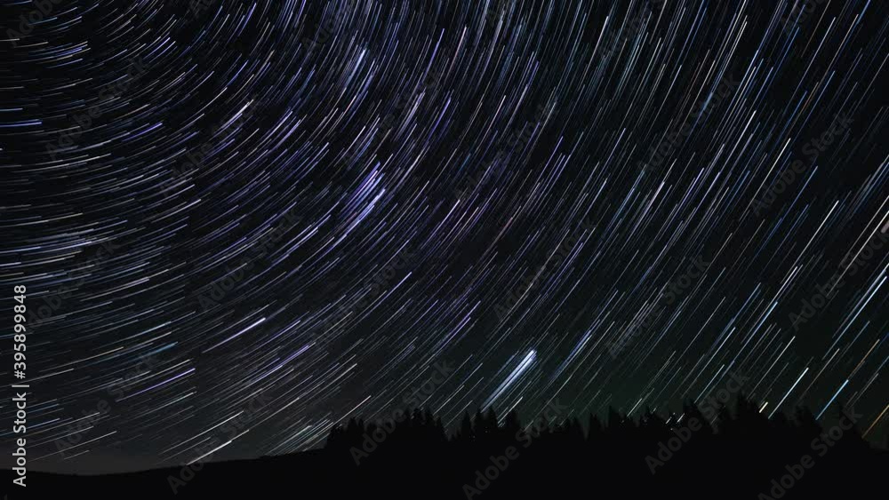 Time lapse of comet-shaped star trails in the night sky. Stars move ...