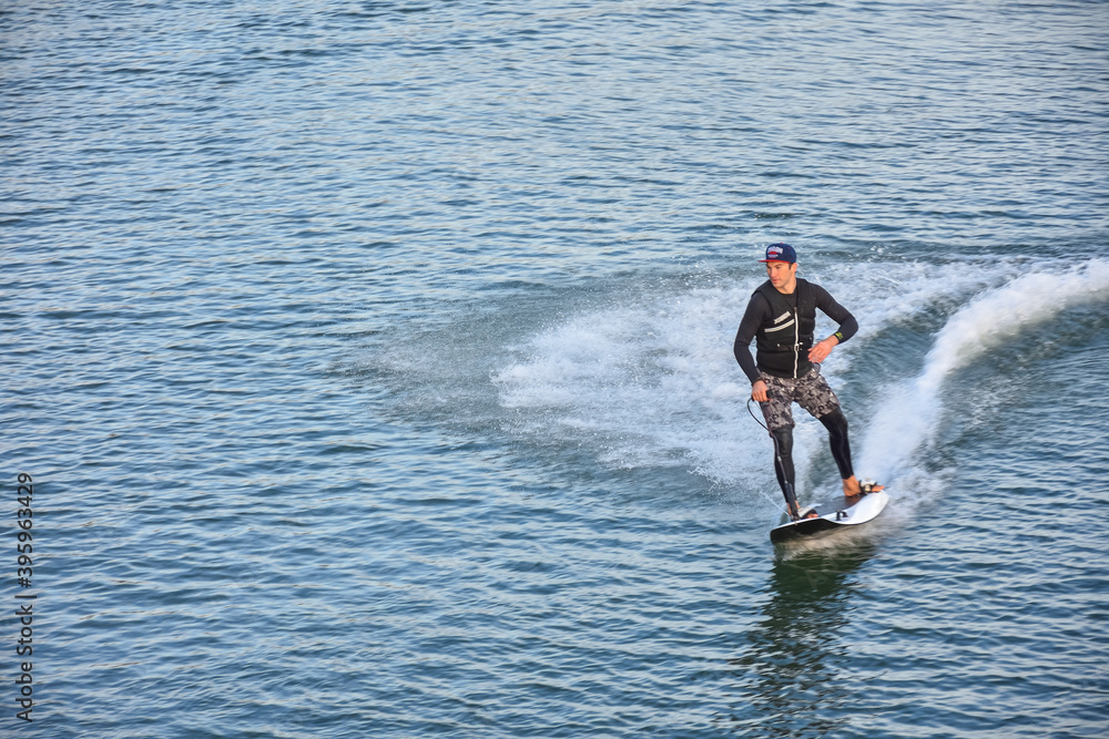 Motosurf Competitor taking corner at speed making a lot of spray. Jet ...
