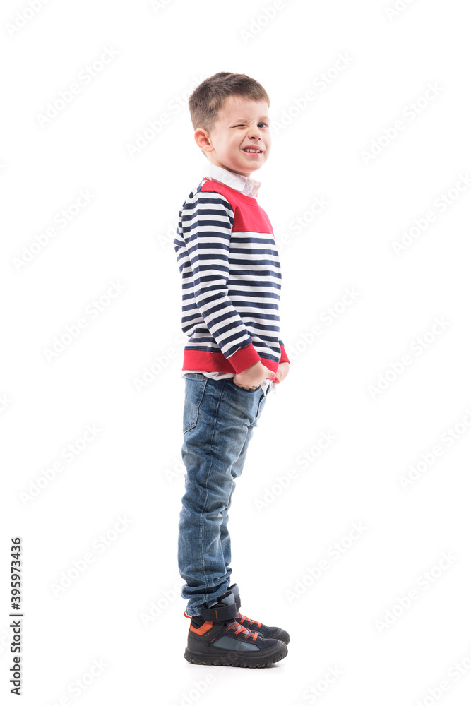 Side view of cute charming little kid turning and winking at camera ...