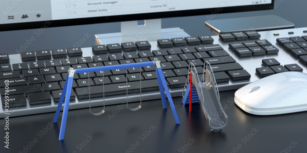 Playground slider and swing set on an office desk, computer keyboard ...
