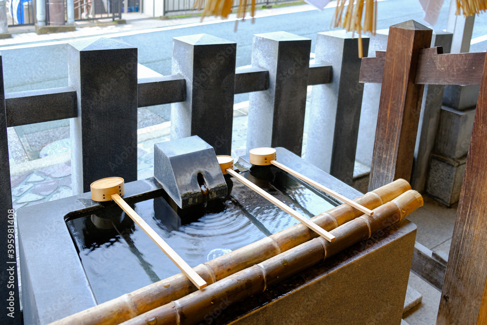 People use wooden scooping water to purify the body before visiting ...