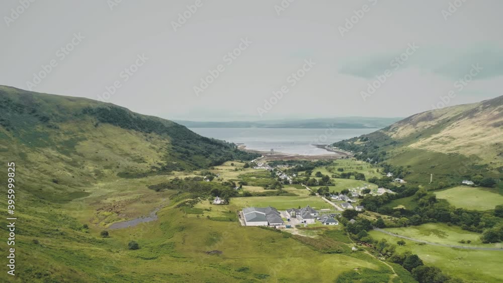 Scotland village at green mountain valley aerial. Scottish hillside ...