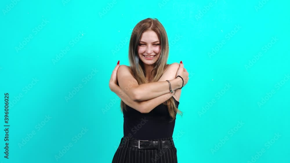 Excited teenager looks in the room and smiles shyly. Charming girl ...