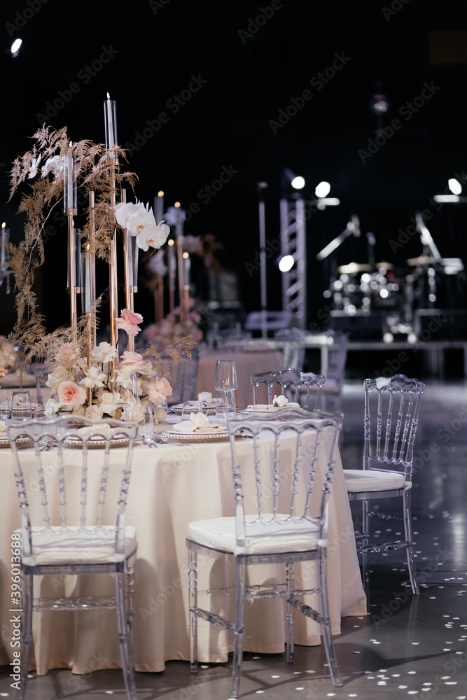 Wedding dining table decorated with flowers and candles. Place for ...