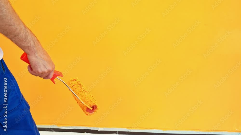 Offering professional painting services. Painter man at work with ...