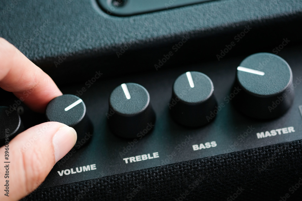 man's hand is adjusting the music volume from the amplifier. Stock ...