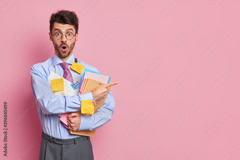 Impressed emotive unshaven man executive stares at camera with shocked ...