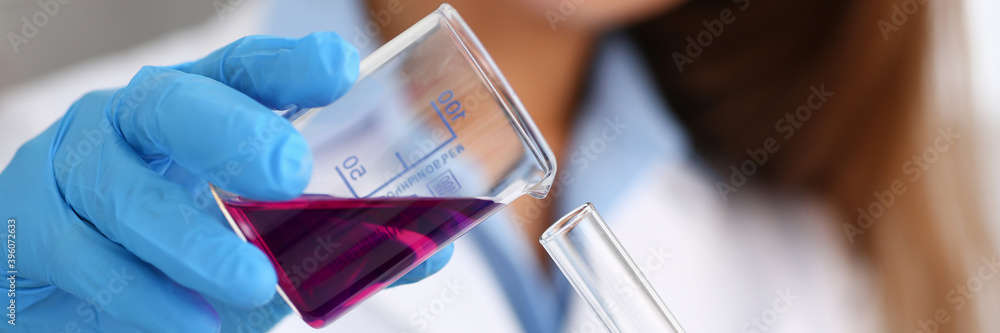 Professional researcher wearing uniform while working with reagents in ...