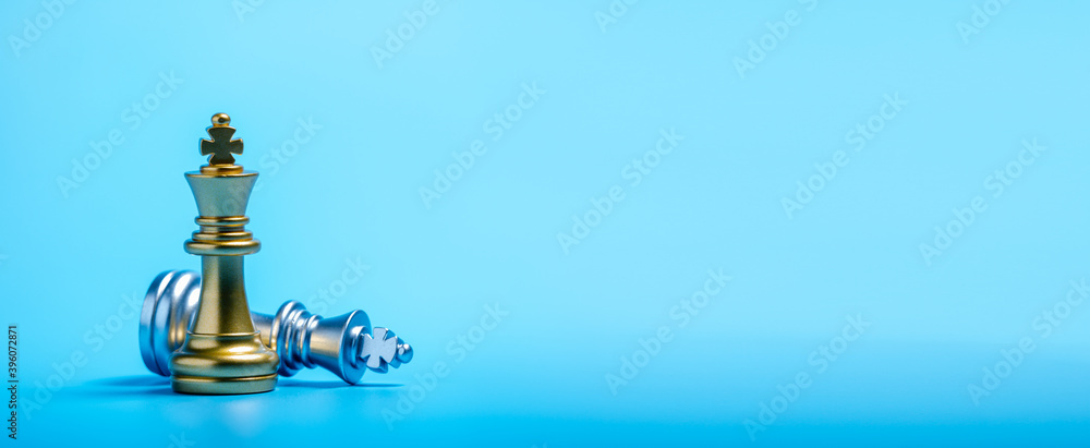 Golden king surrounded with chess pieces on chess board with sky blue ...