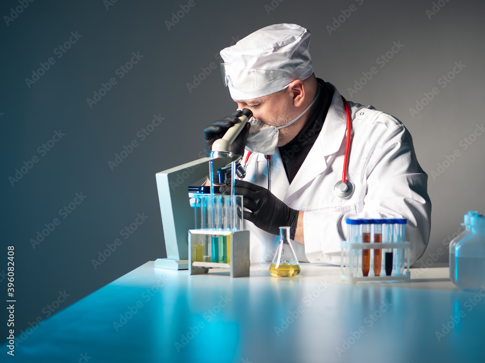 Doctor works in laboratory. Medic in laboratory looks through a ...
