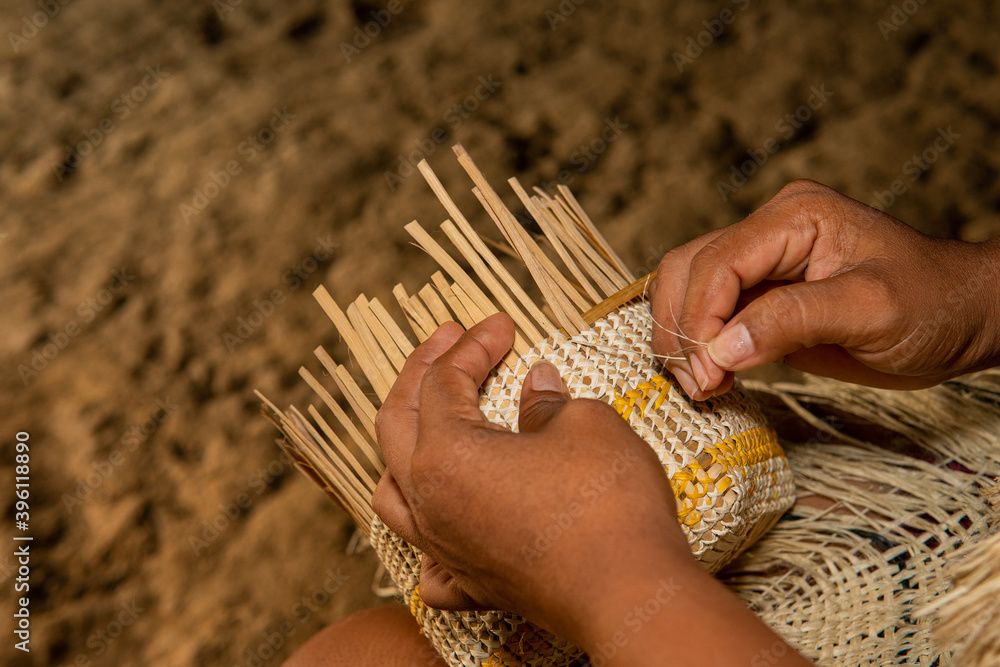 indigenous woman from the uitoto tribe of the colombian amazon weaving ...