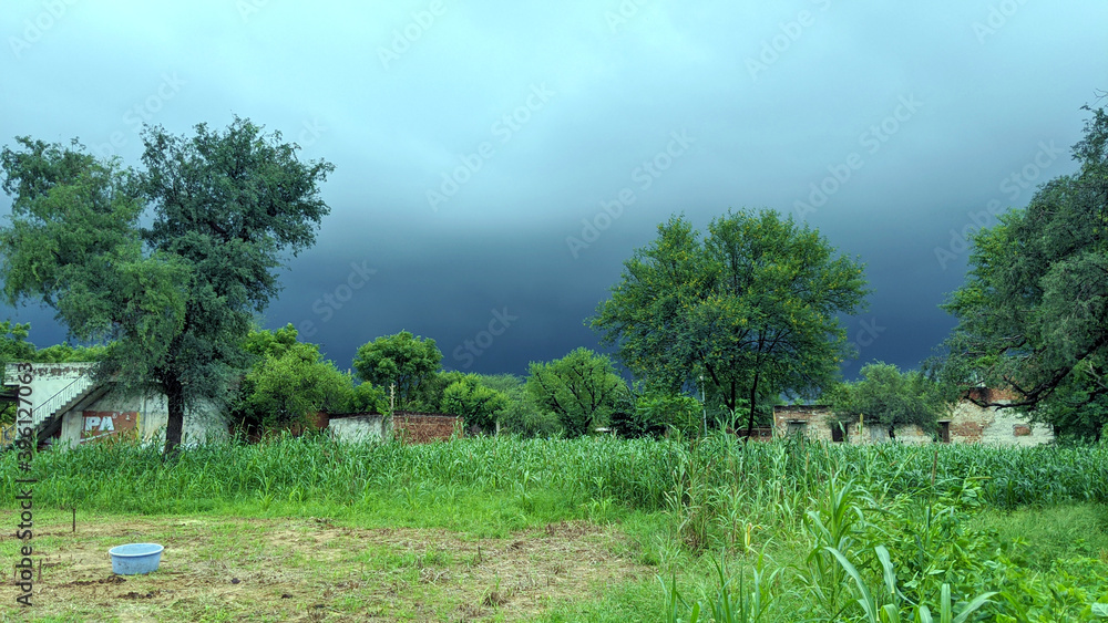 Raining dark cloud over field in big farmland. dramatic rain clouds ...