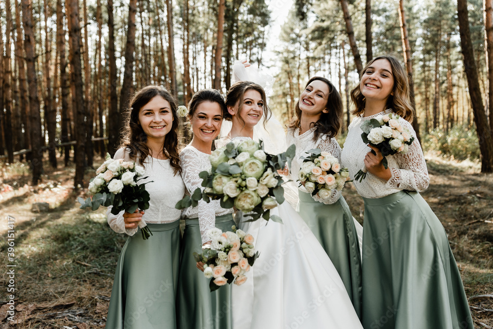 beautiful laughing girls in wedding dresses hold bouquets with flowers ...