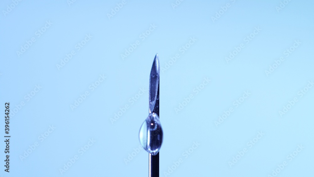 Vaccine dripping from sterile needle syringe macro close up ...