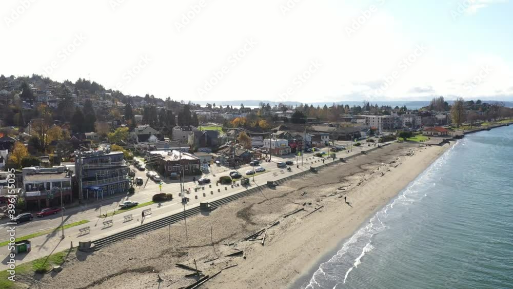 Aerial / drone footage of Alki Beach, sandy shoreline with a bike ...