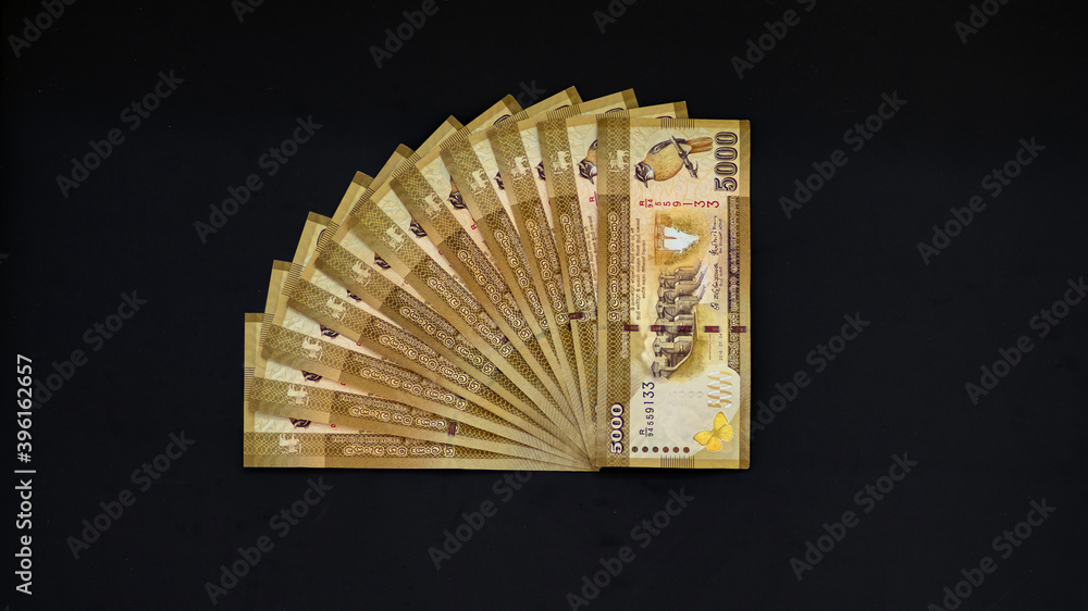 5000 Sri Lankan rupee notes stack on a black background. making a ...