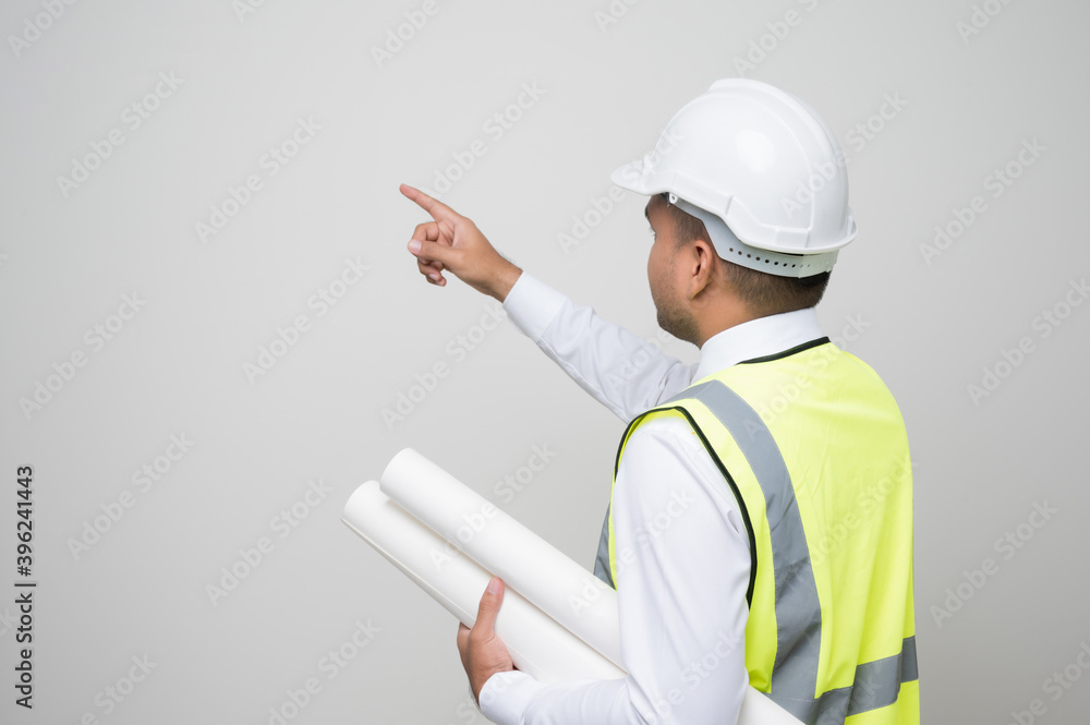 Rear view asian civil engineer holding paperwork blueprint roll ...