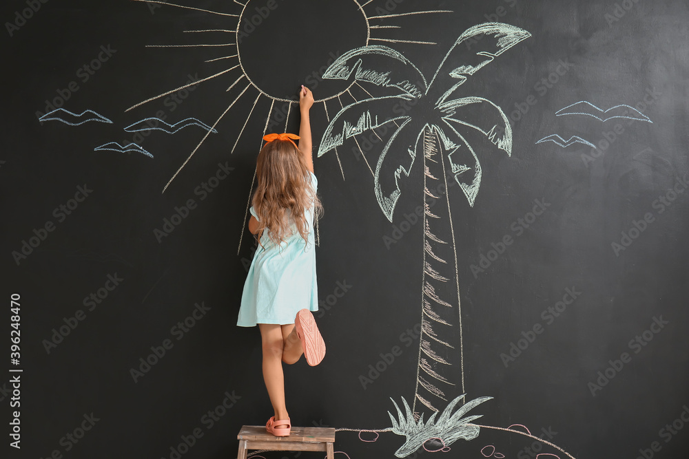 Cute little girl drawing sun on black wall Stock Photo | Adobe Stock