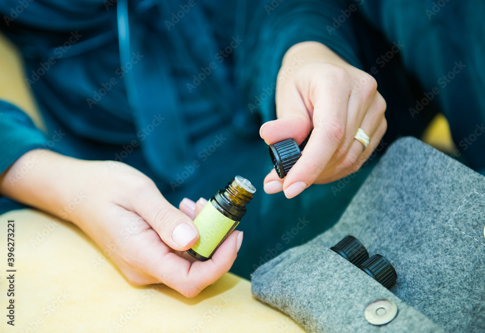 Aromatherapy. Girls hand with beautiful skin holds open bottle of ...