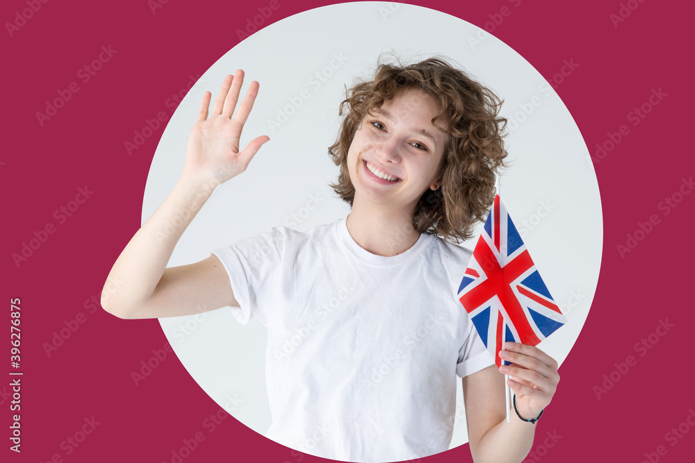 Portrait of a young smiling woman with the flag of Great Britain in a ...