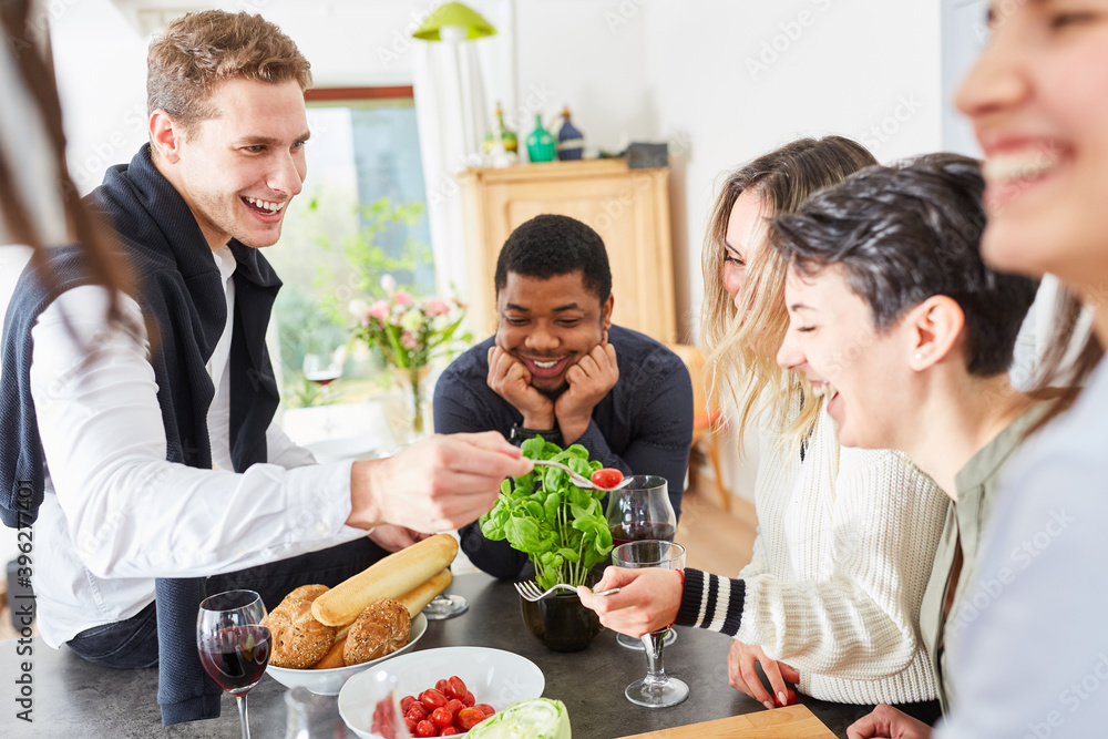 Laughing friends together in kitchen prepare food Stock Photo | Adobe Stock