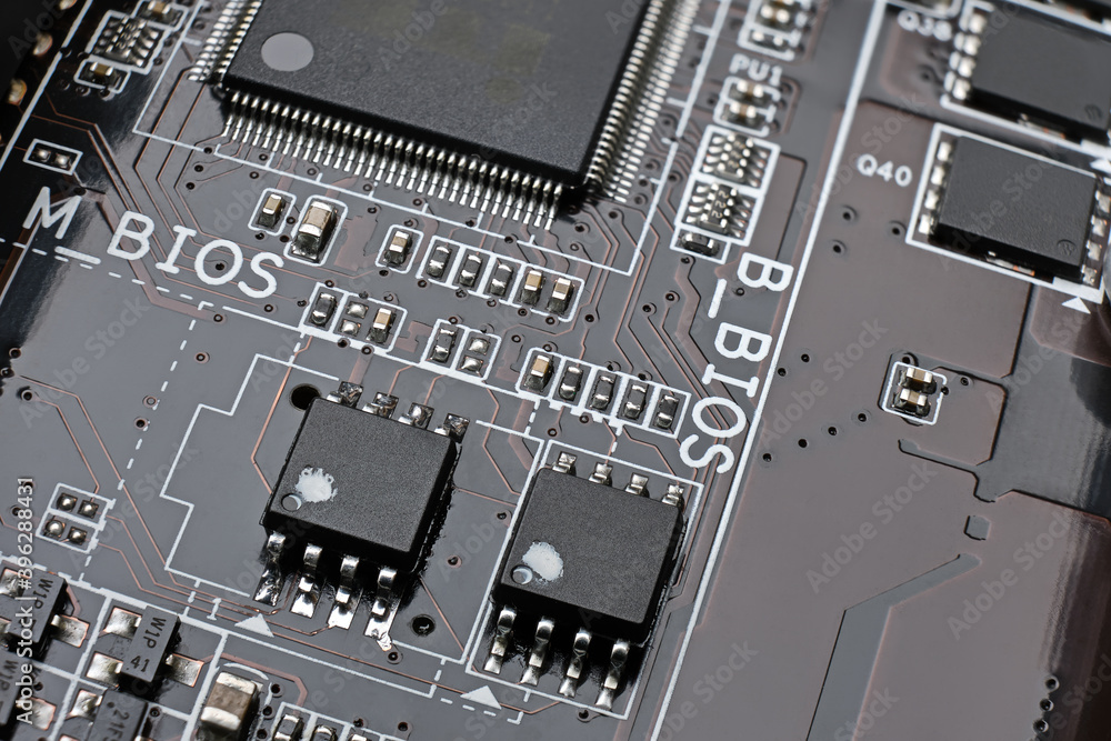 Brown motherboard pcb close up shot with dual bios chips, surface mount ...