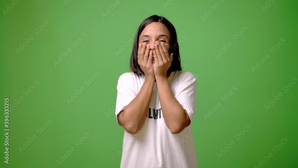 Young volunteer woman on green screen chroma key background with ...