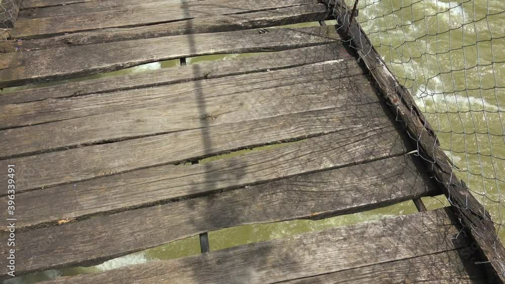 Wooden Simple Suspension Bridge Over River in Valley.A simple ...